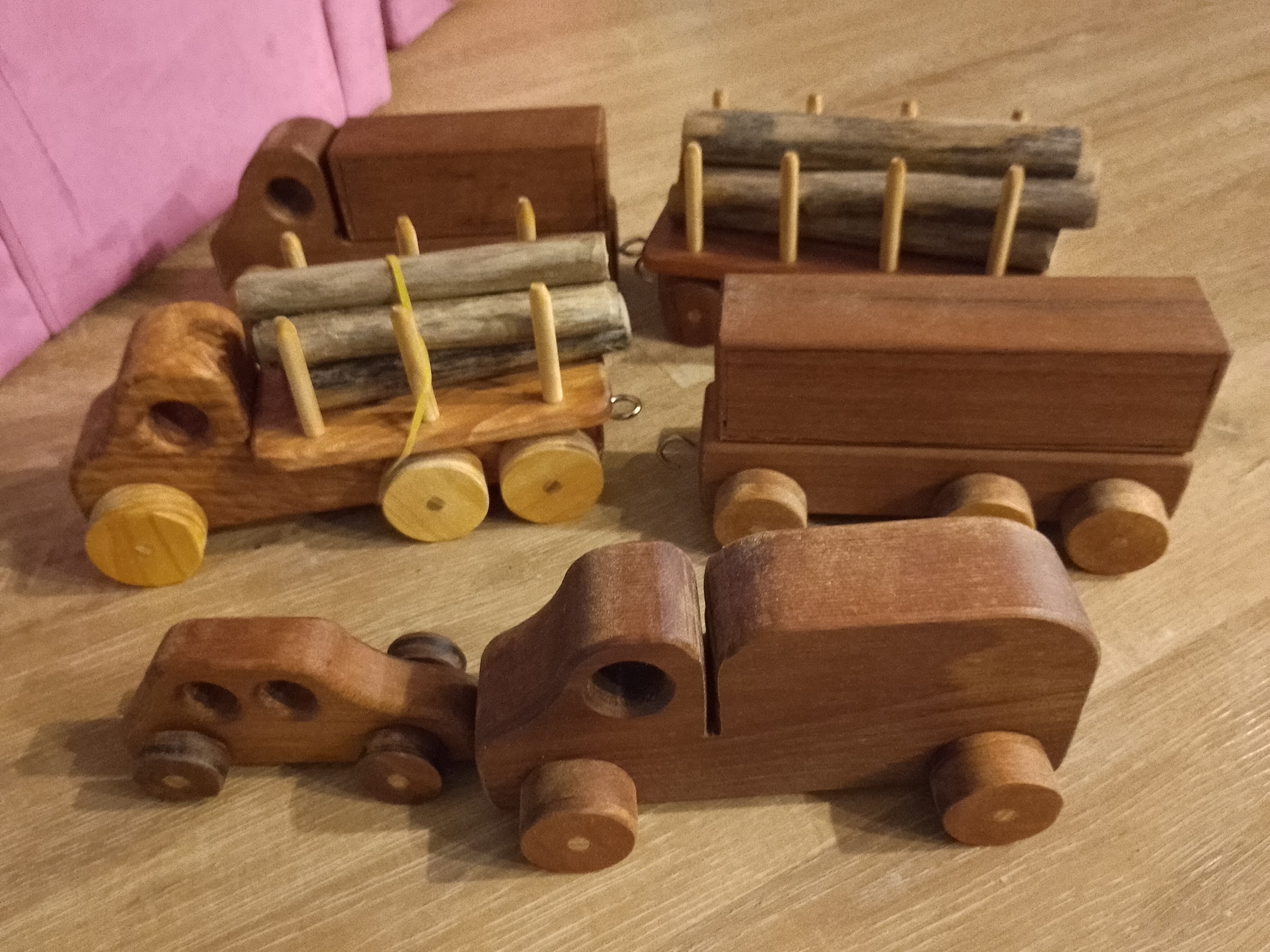 Wooden trucks, logs, bus and car