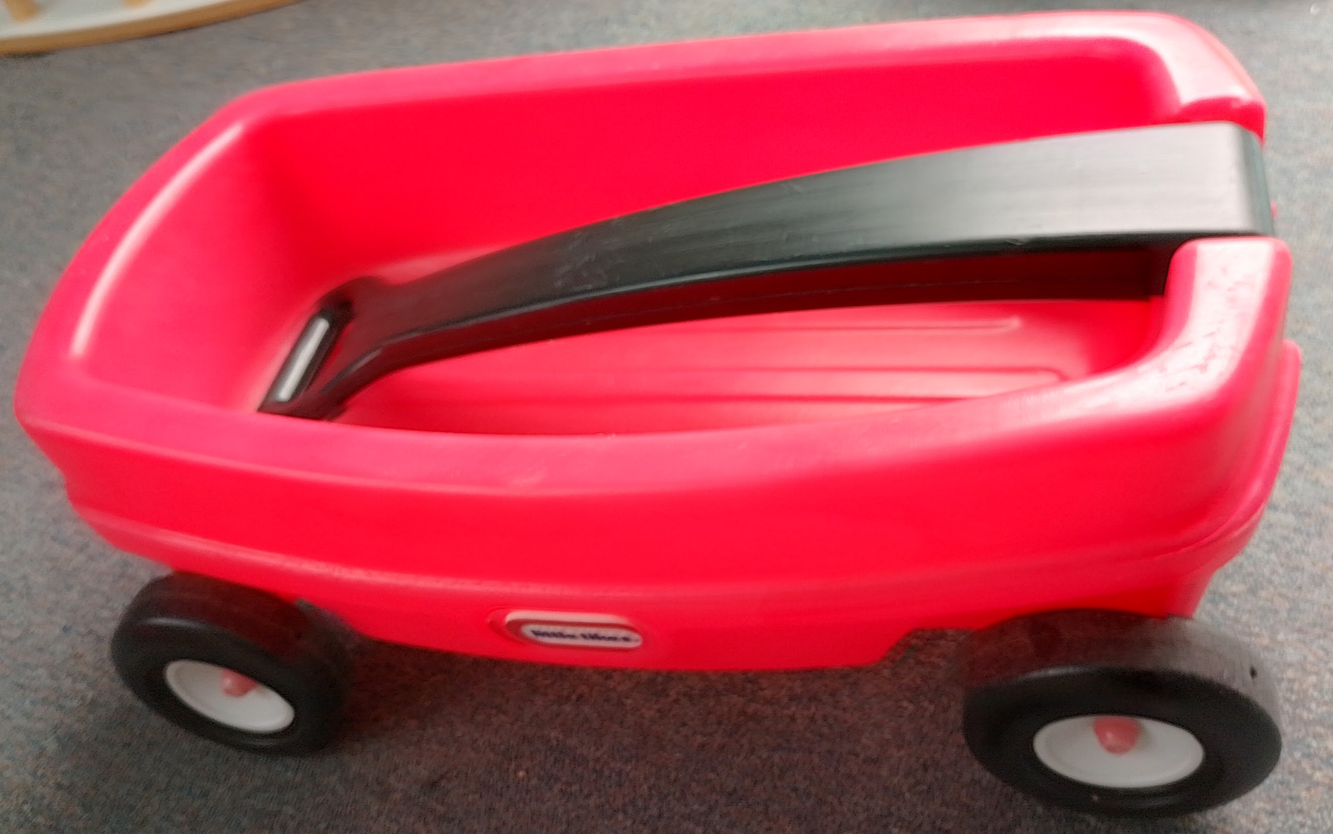 Small red pull along wagon